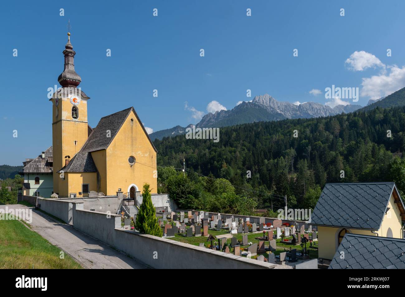 The church of San Leonardo (15th century) in the alpine town of Fusine ...