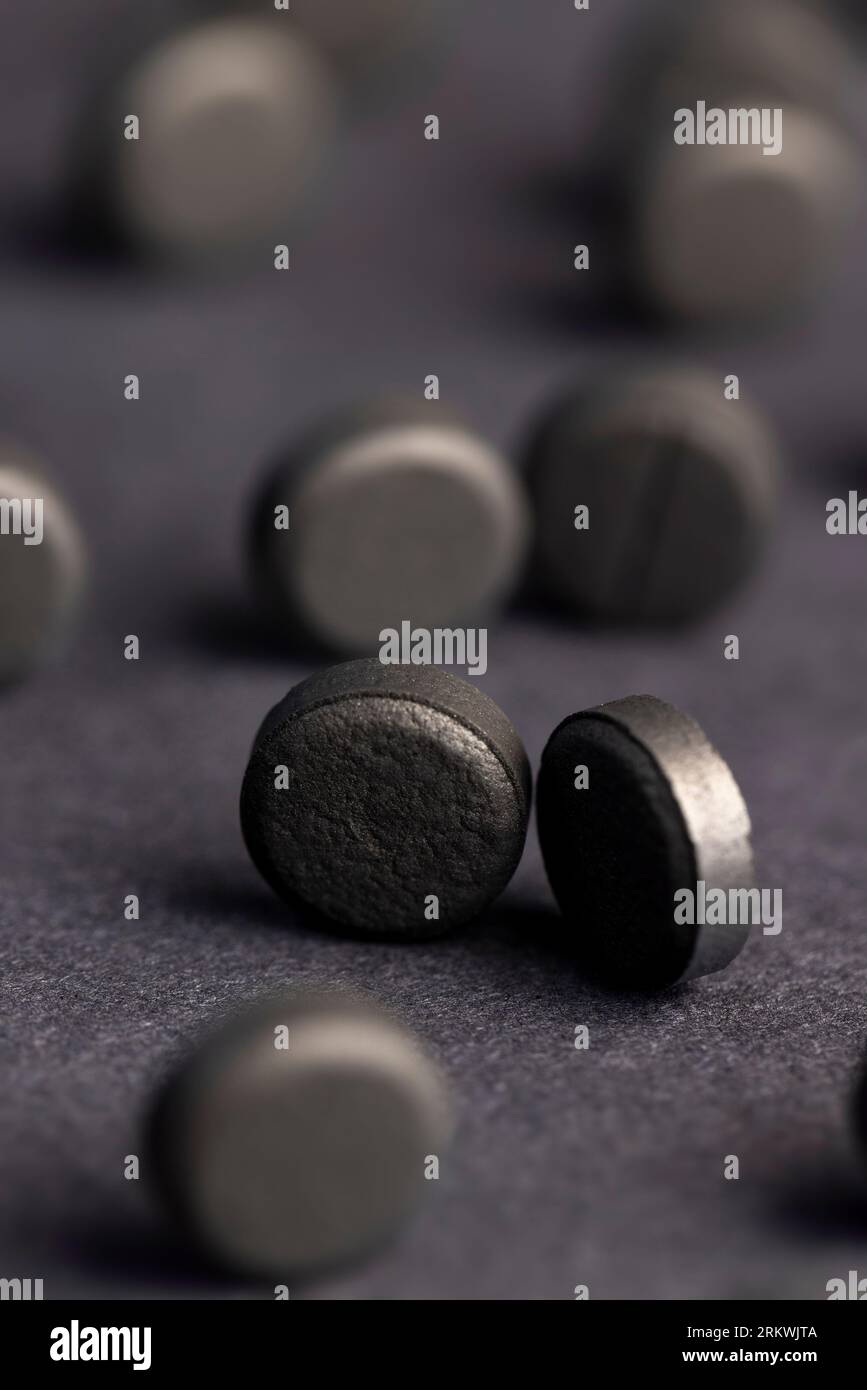 Open and unpacked tablets of black color close-up, a large number of ...