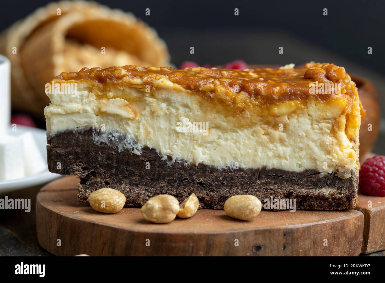 Cheesecake with chocolate sponge cake and peanuts in caramel, delicious ...