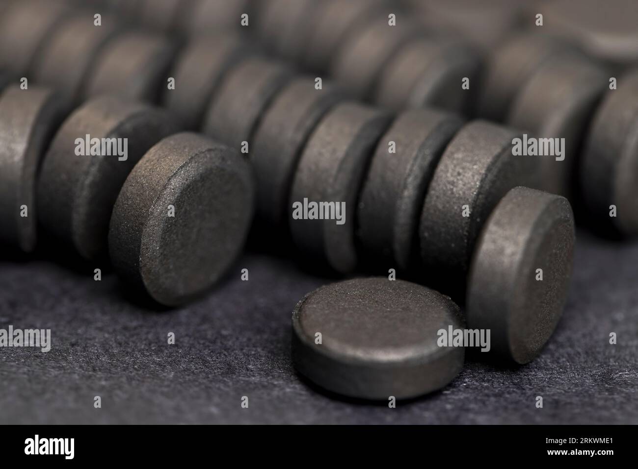 Open and unpacked tablets of black color close-up, several of the same ...