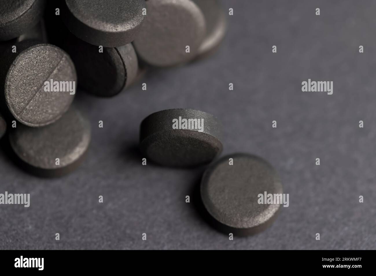 Open and unpacked tablets of black color close-up, a large number of ...