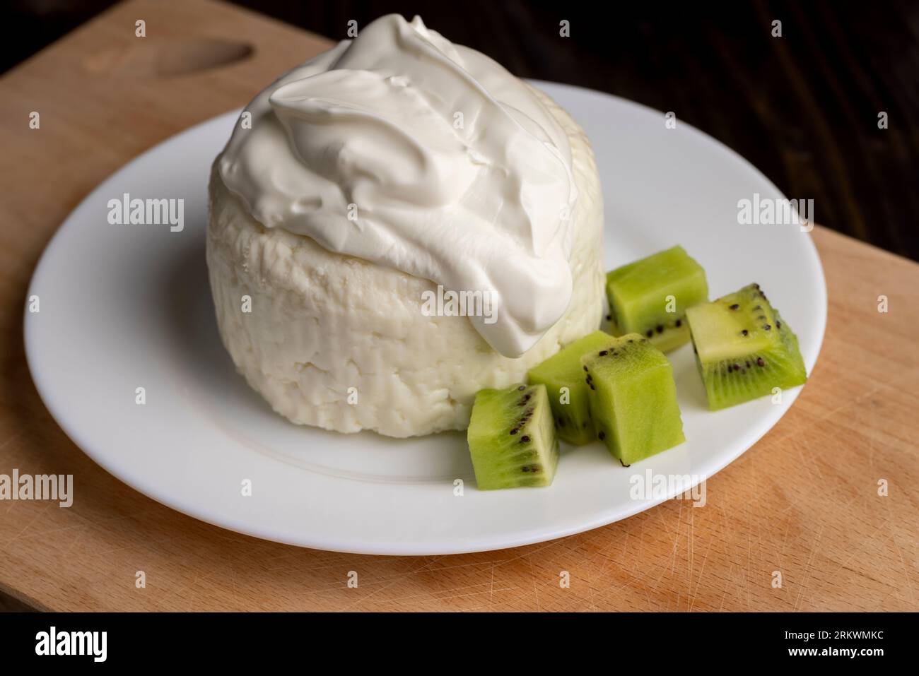 White cottage cheese with sour cream, making a dairy breakfast with ...
