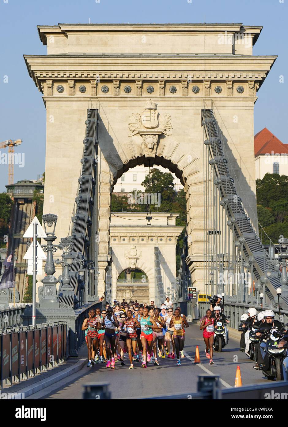 Athletes cross the Szechenyi Chain Bridge in the women's marathon at ...