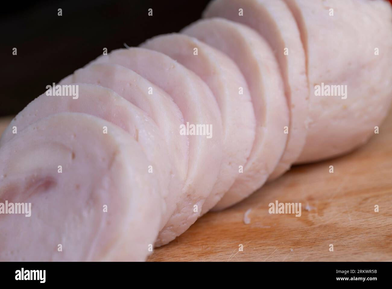 Sliced round-shaped ham from chicken meat, freshly sliced chicken ham ...