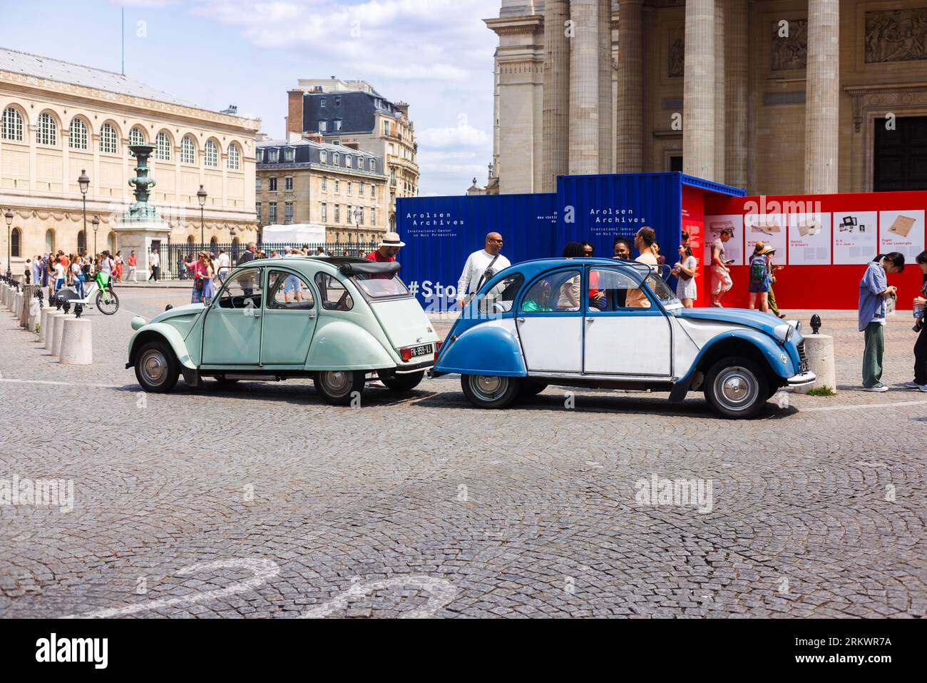 The Citroen 2CV cars parked in the bustling street of Paris Stock Photo ...