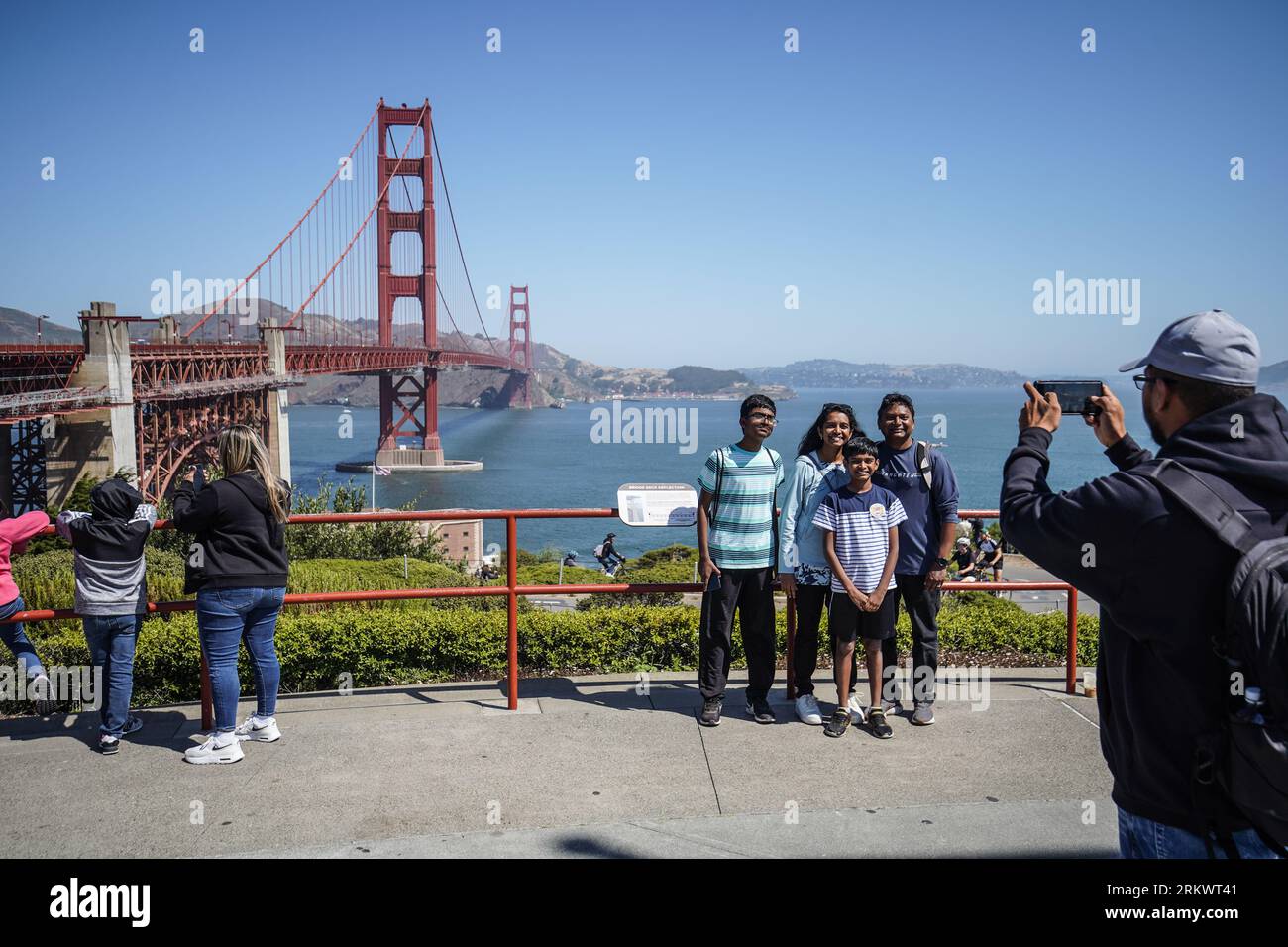 People take photos in front of the Golden Gate Bridge in San Francisco ...