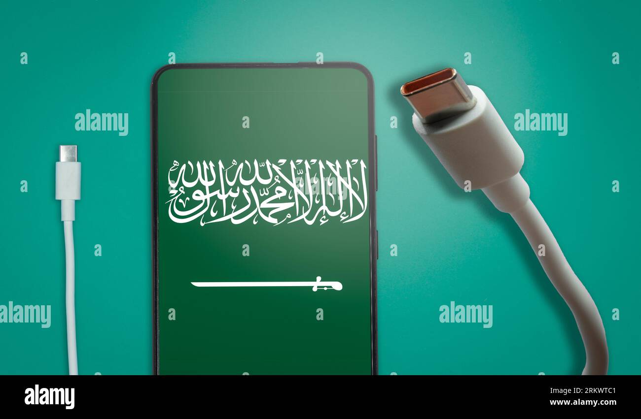 USB-C cable and a smartphone with the Saudi Arabia Flag on screen Stock ...