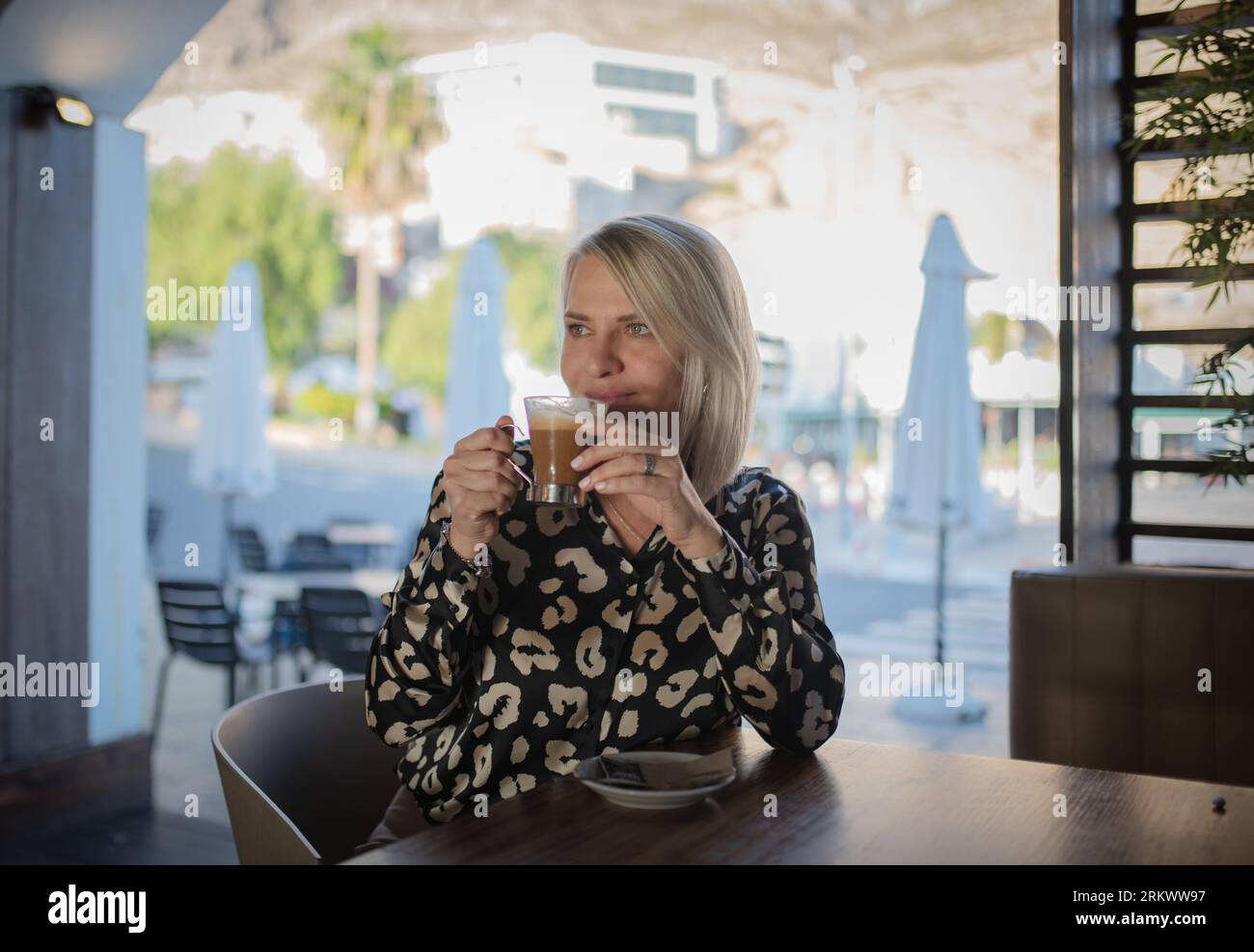 woman drinking coffee in the morning at restaurant Stock Photo - Alamy