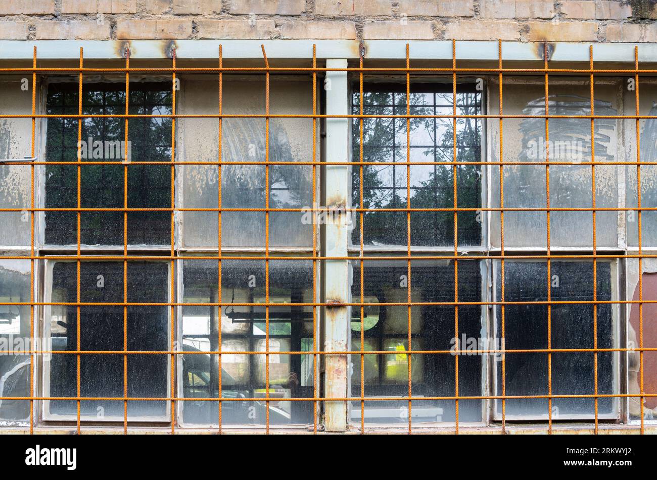 Gridded and smeared windows of an abandoned factory Stock Photo - Alamy