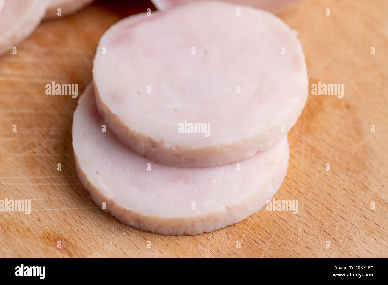 Sliced round-shaped ham from chicken meat, freshly sliced chicken ham ...