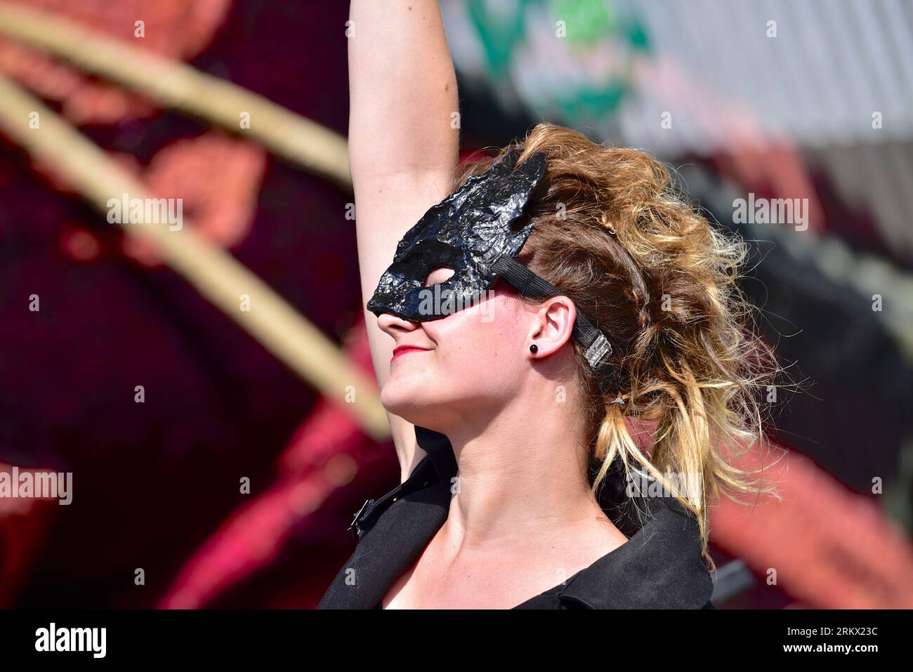 Young woman performs her music and dance act on a float during flower ...