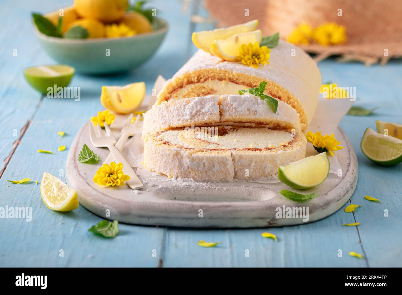 Homemade mango swiss roulade served as summer dessert. Swiss roll with ...