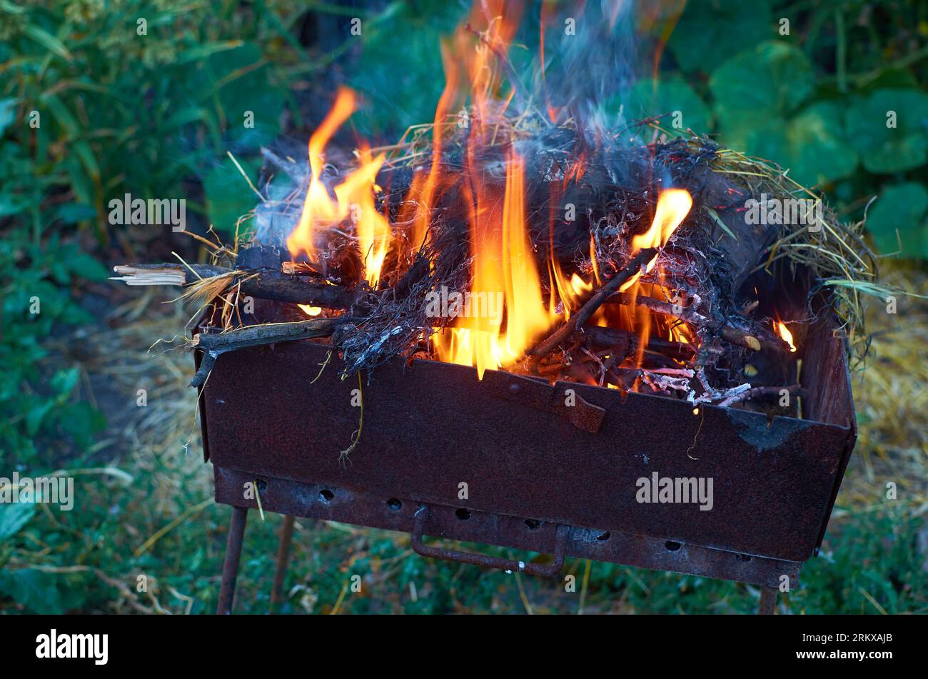 Outdoors metall rusty grill barbecue, flames of fire with smoke ...