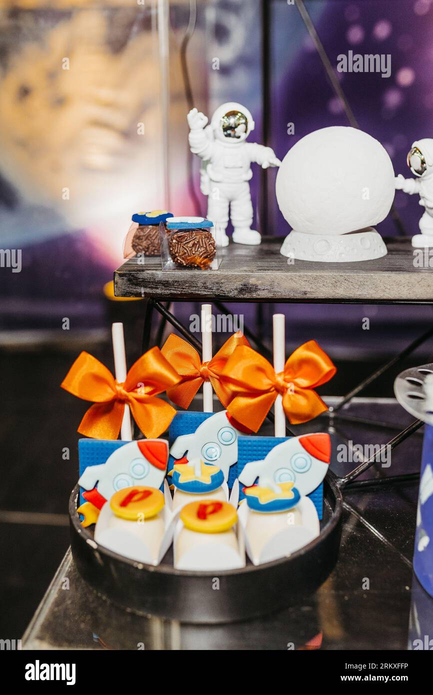 An assortment of vibrant cake pops decorated with rocket designs on a ...