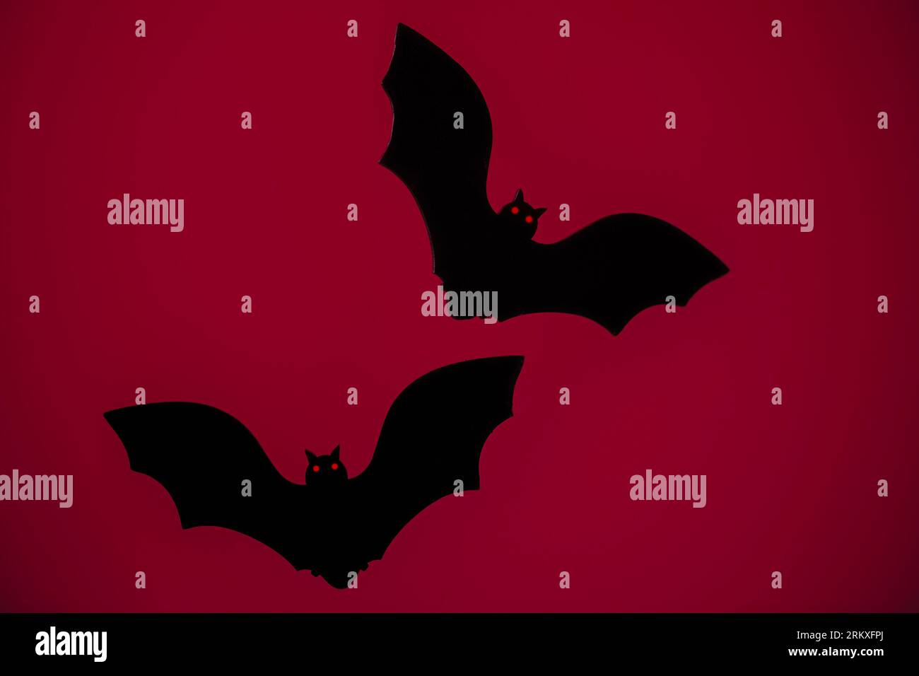 Wooden bats isolated on a red background Stock Photo - Alamy