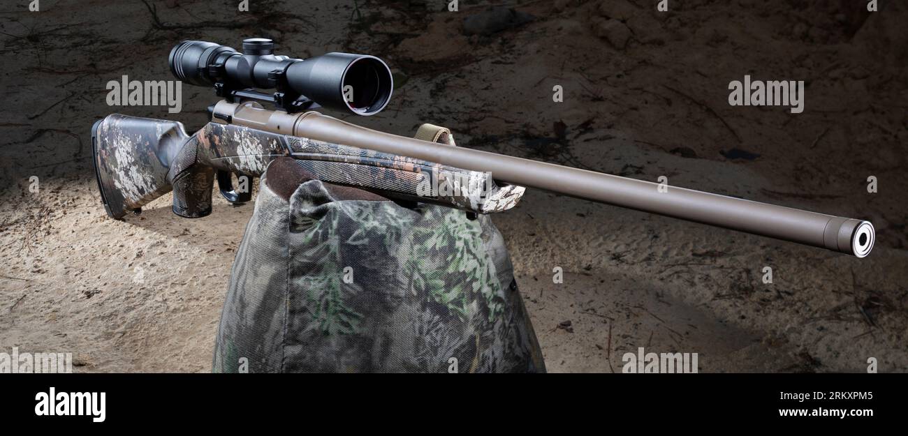 Bolt action centerfire rifle with a telescopic rifle scope on a sandbag ...