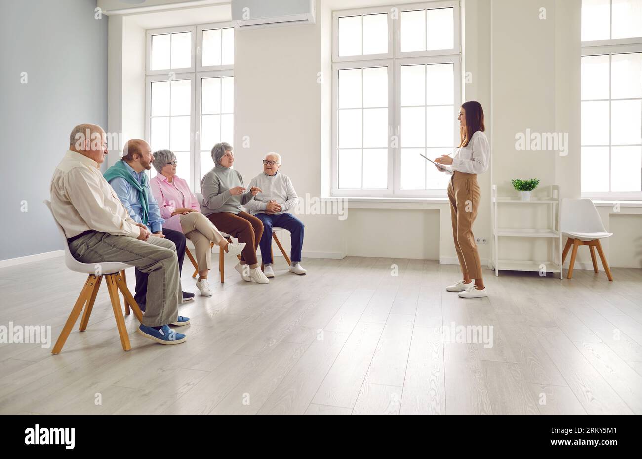 Psychologist checks mental health of elderly people during group ...