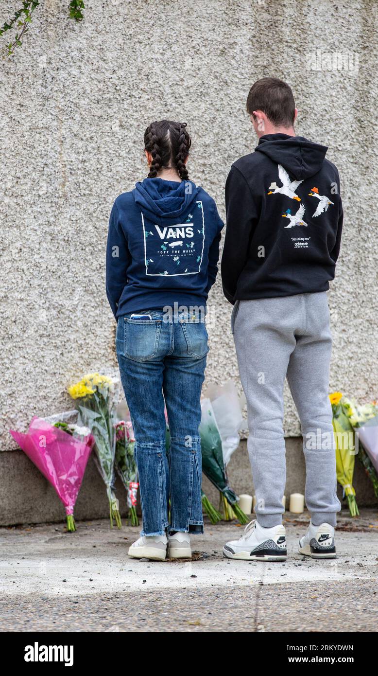 People look stand by flowers near to the scene of a fatal crash which ...