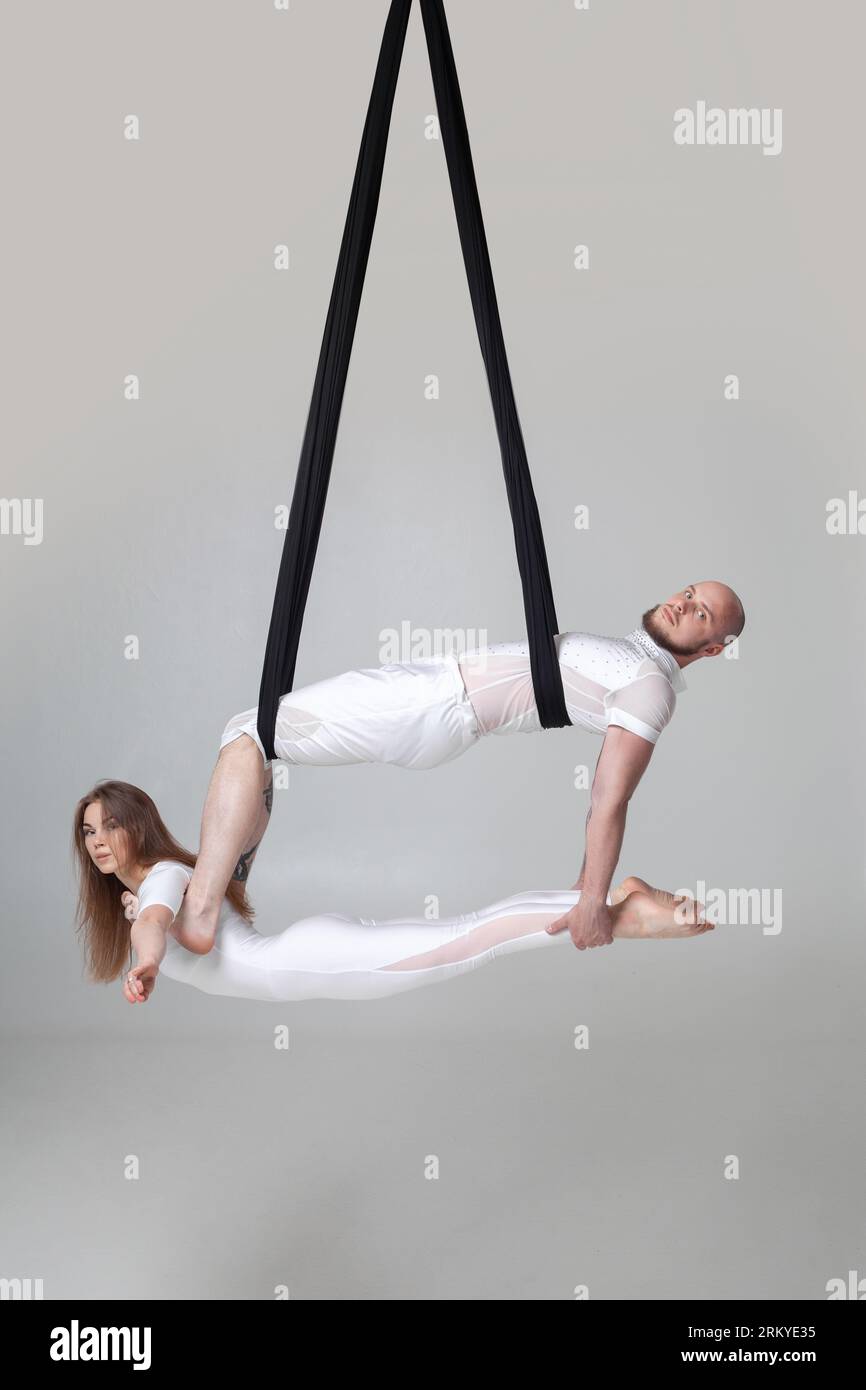 Beautiful girl and an athletic man in a white sport suits are ...