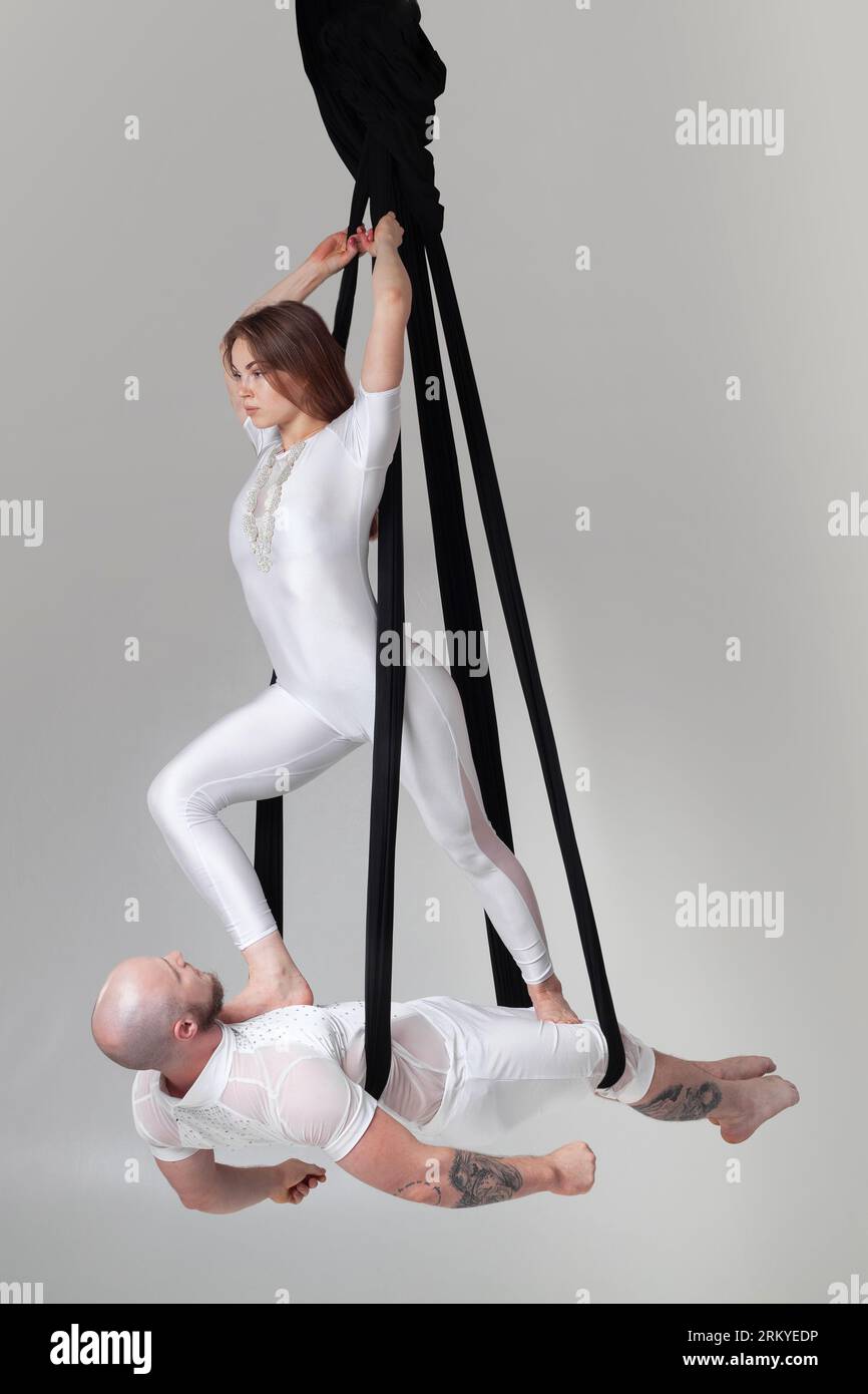 Beautiful girl and an athletic man in a white sport suits are ...