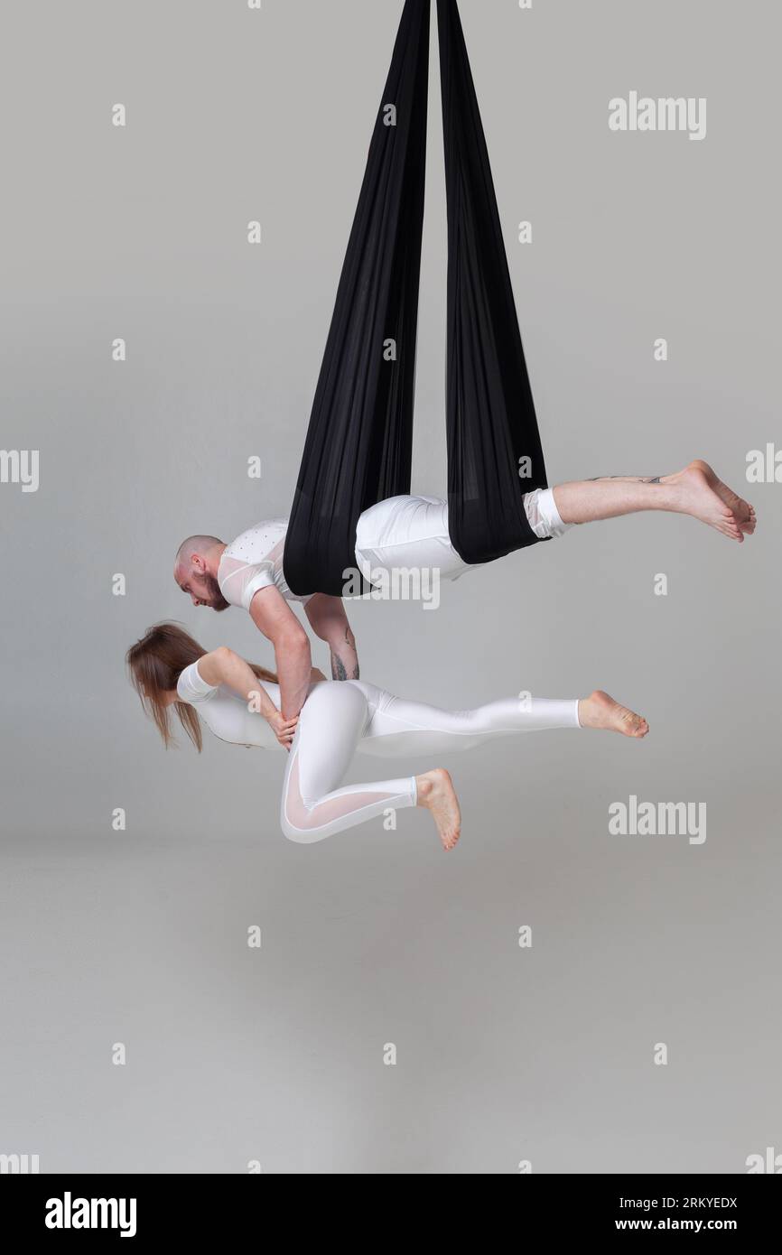 Beautiful girl and an athletic man in a white sport suits are ...