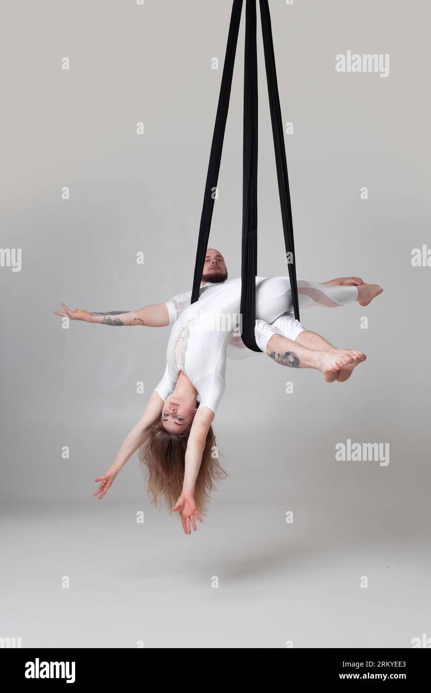 Beautiful girl and an athletic man in a white sport suits are ...