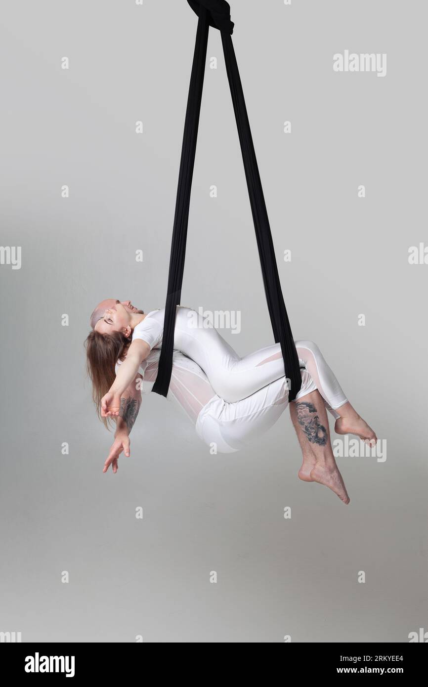 Beautiful girl and an athletic man in a white sport suits are ...