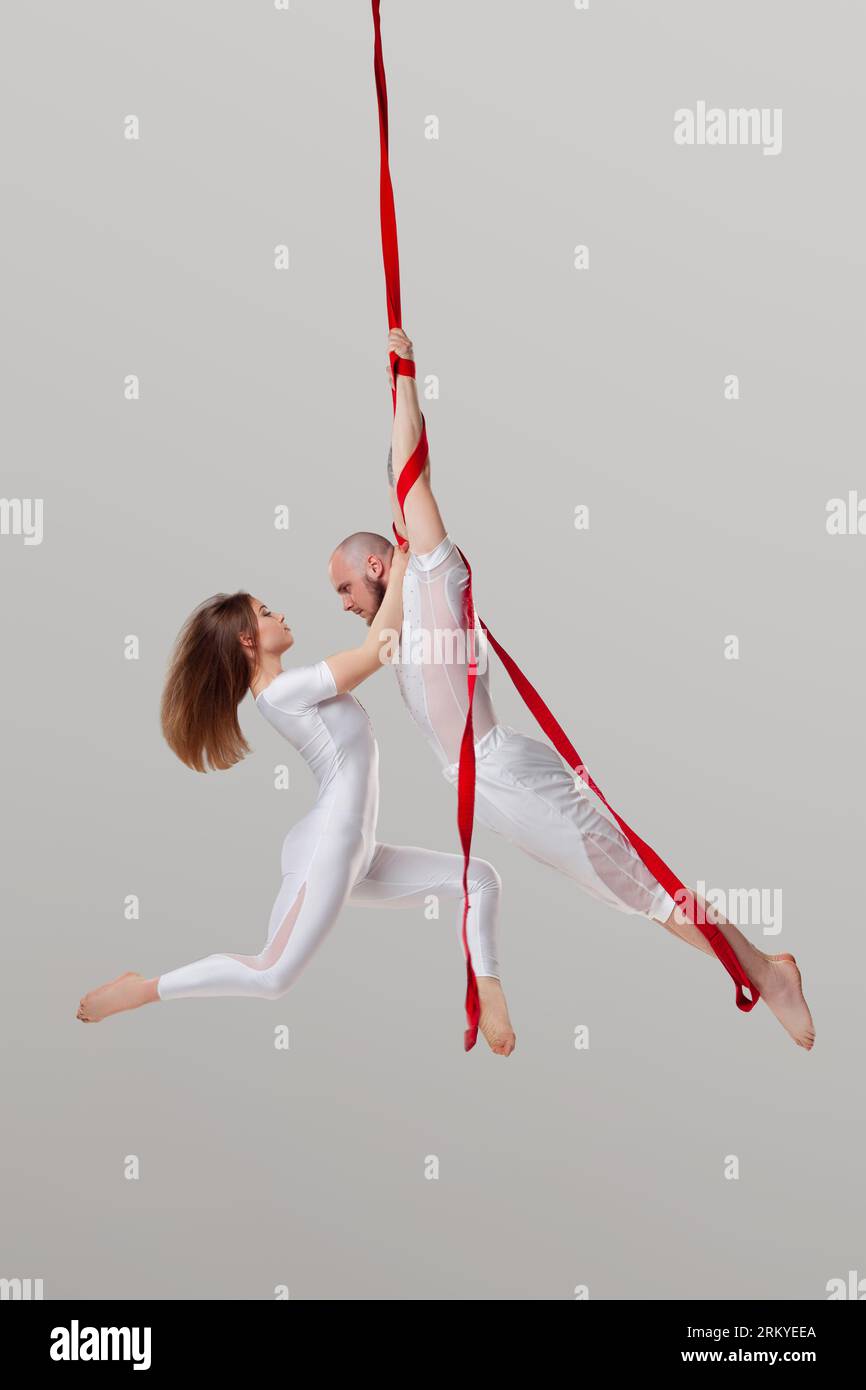 Beautiful girl and an athletic man in a white sport suits are ...