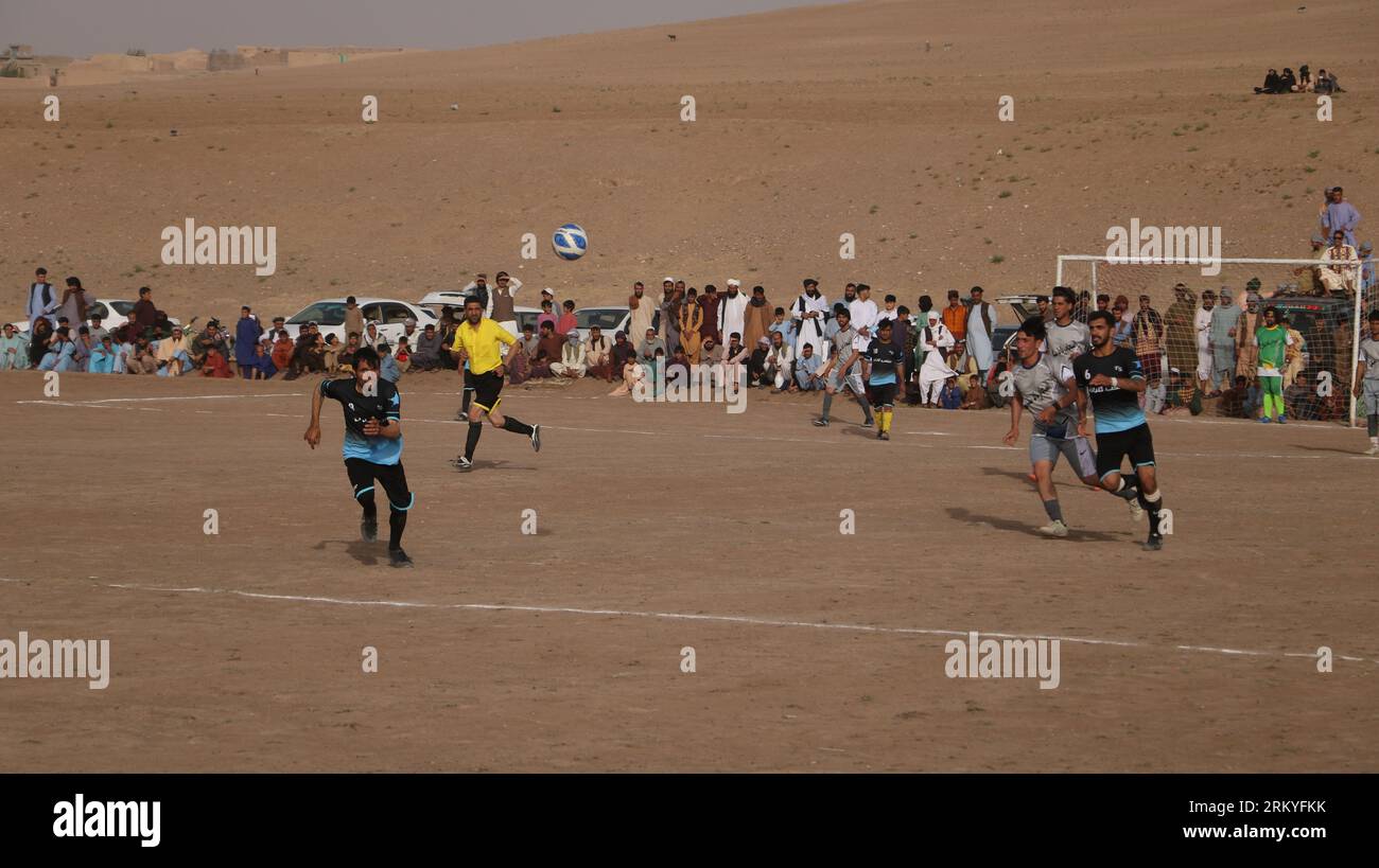 Herat, Afghanistan. 25th Aug, 2023. Young Afghans play football on a ...