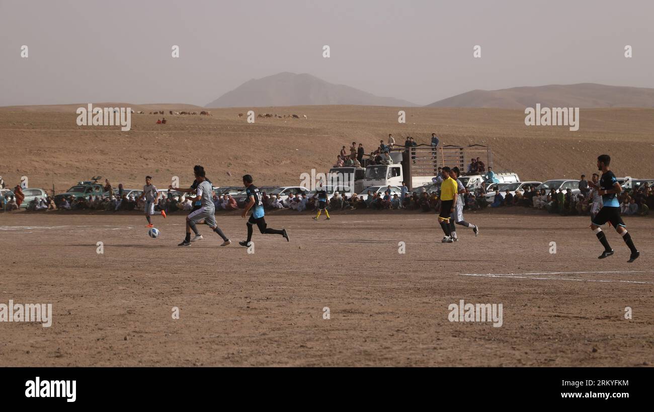 Herat, Afghanistan. 25th Aug, 2023. Young Afghans play football on a ...