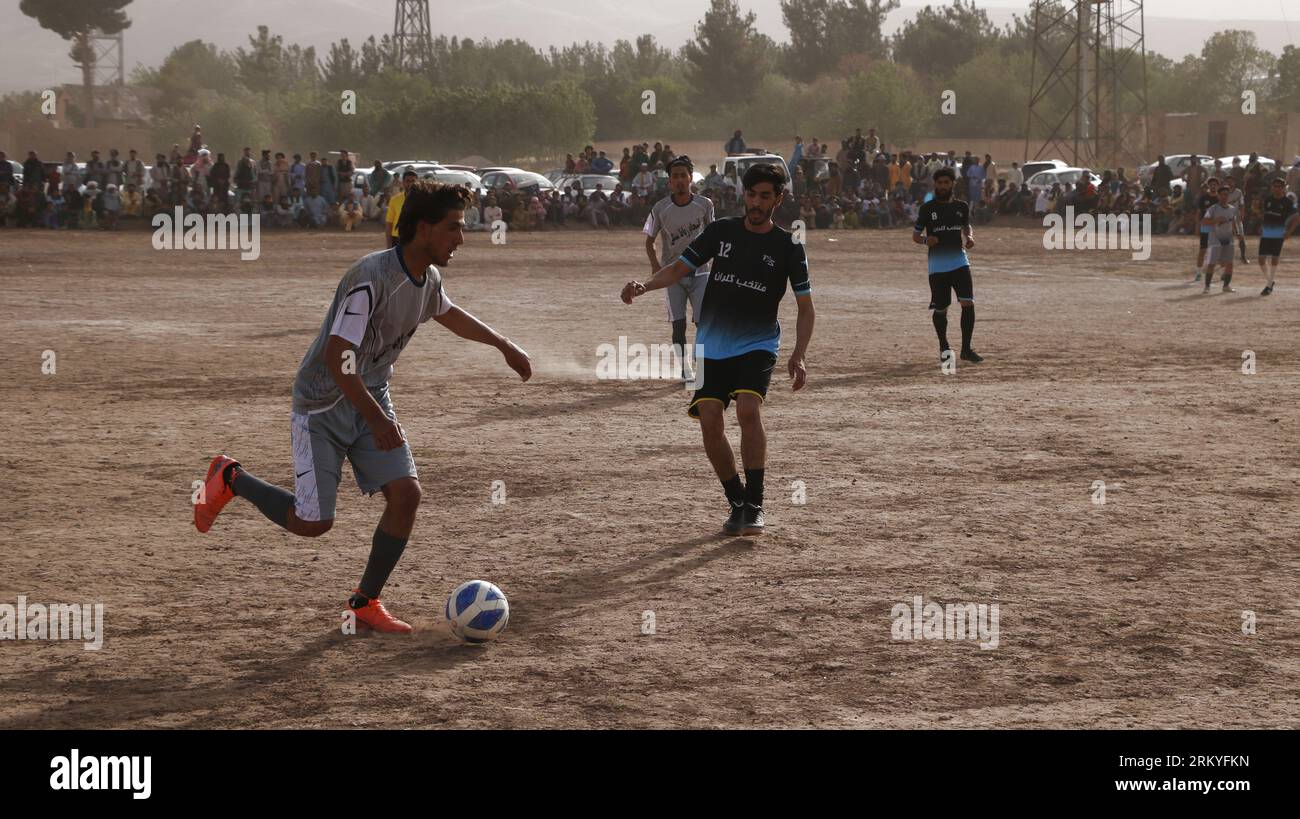 Herat, Afghanistan. 25th Aug, 2023. Young Afghans play football on a ...