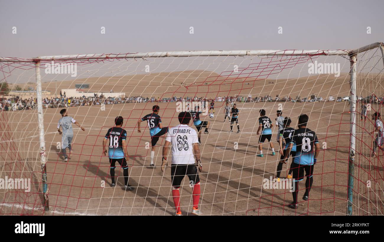 Herat, Afghanistan. 25th Aug, 2023. Young Afghans play football on a ...