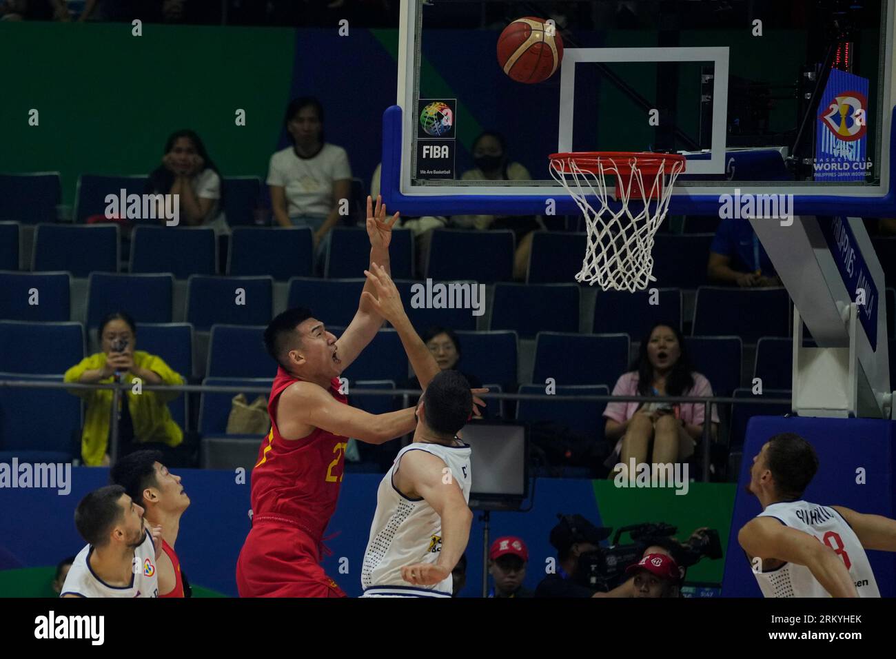 China center Hu Jinqiu (21) shoots over Serbia center Dusan Ristic (14 ...