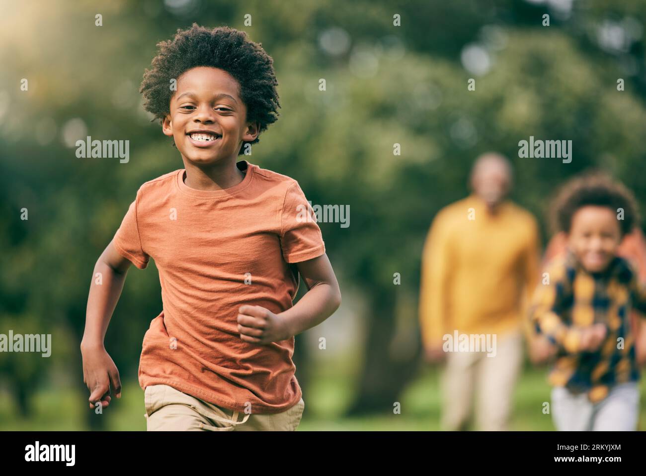 Portrait, running and children at a park with parents, freedom and ...