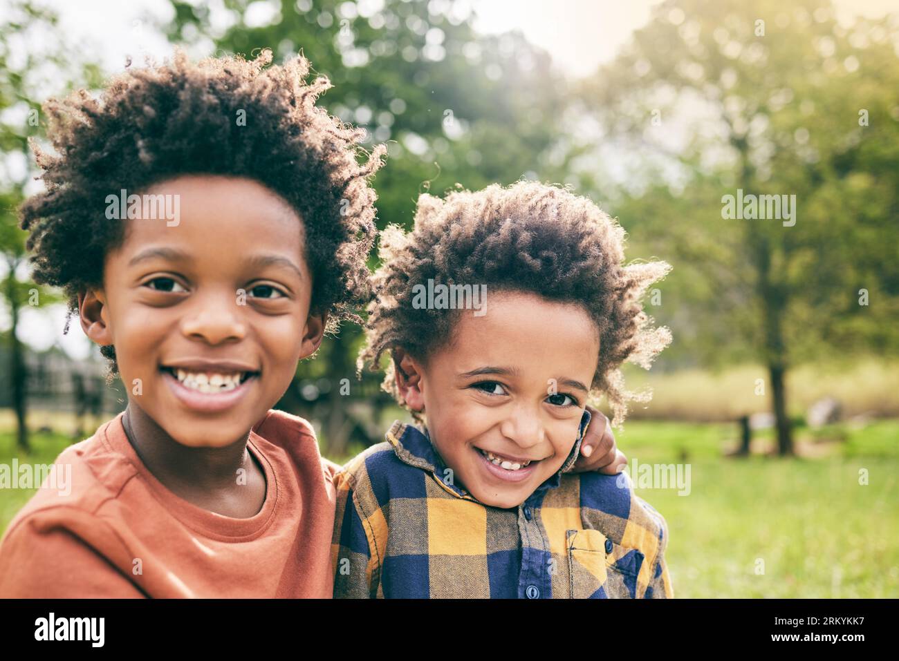 Portrait, boy and brothers hug outdoor in garden, park and nature for ...