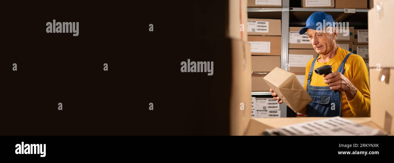 Senior male worker scanning barcode on delivery parcel. Worker scan ...