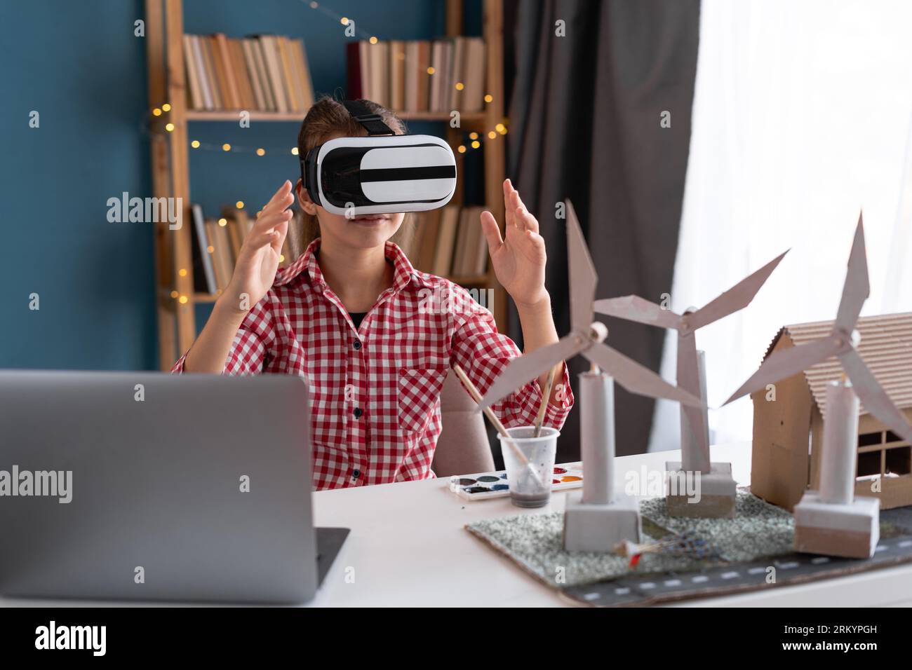 Girl student wearing VR headset and reaching out while testing ...