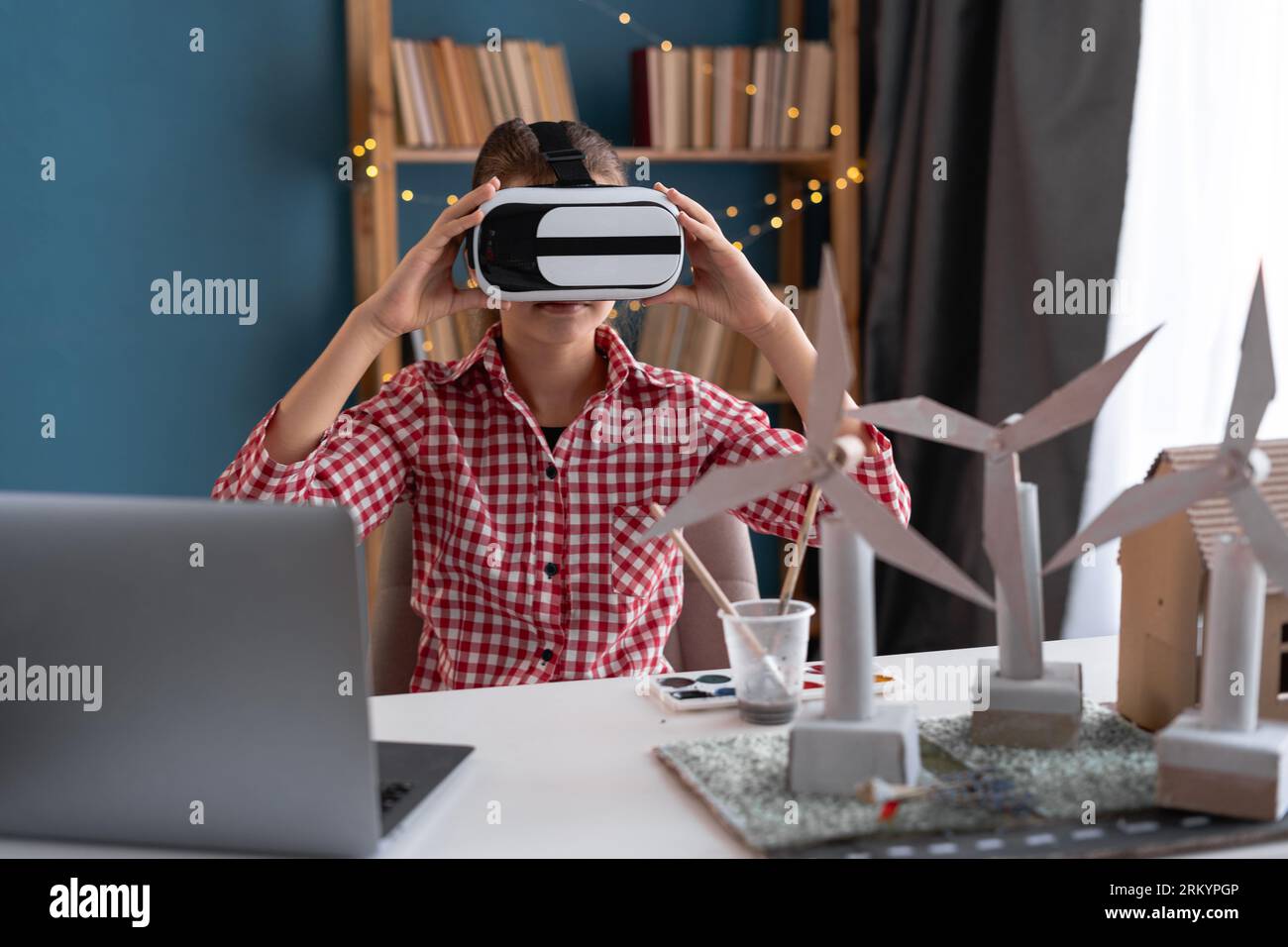 Girl wearing augmented reality headset work with 3D green building ...