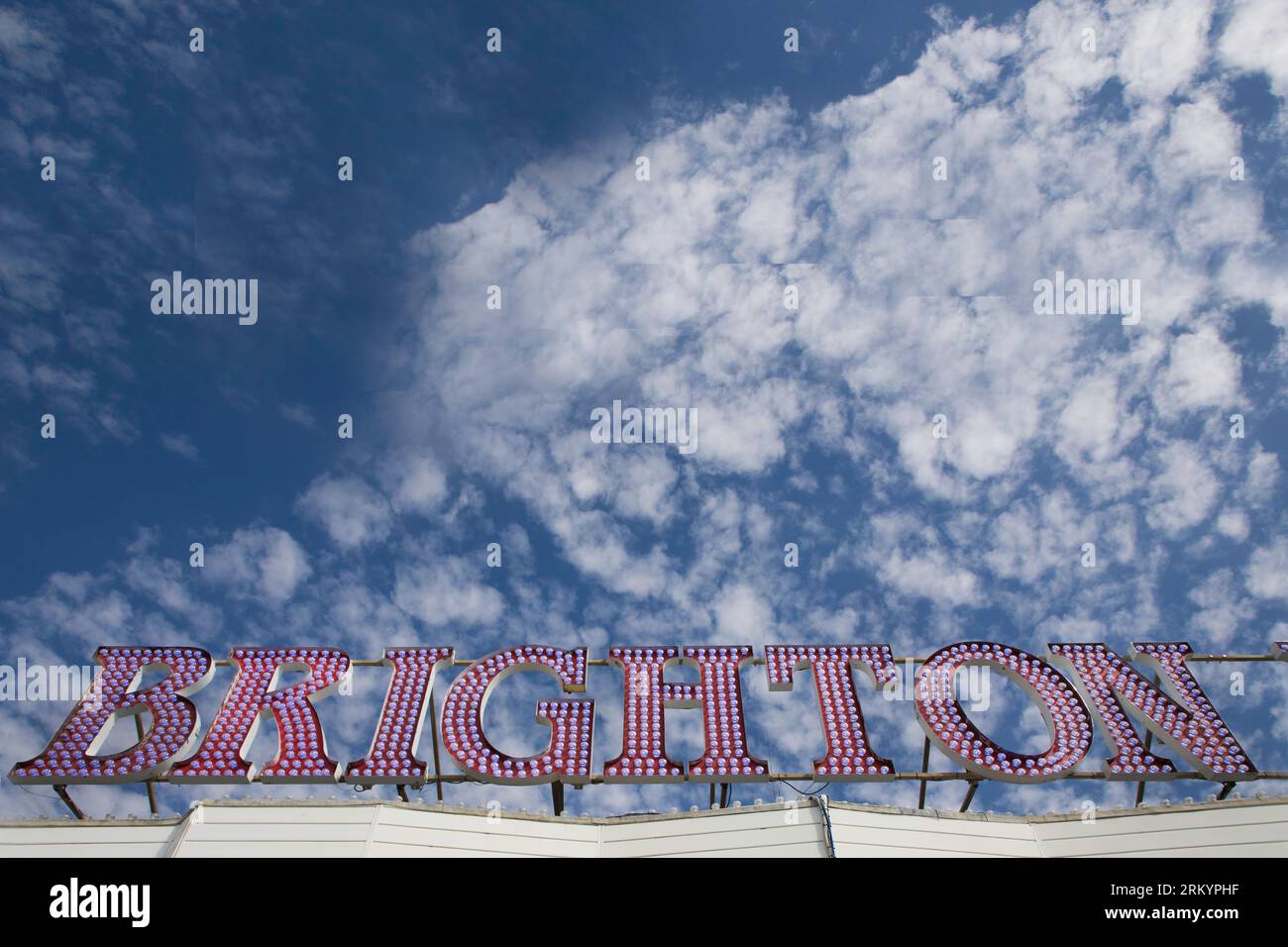 Brighton Pier neon sign with bright blue skies Stock Photo - Alamy