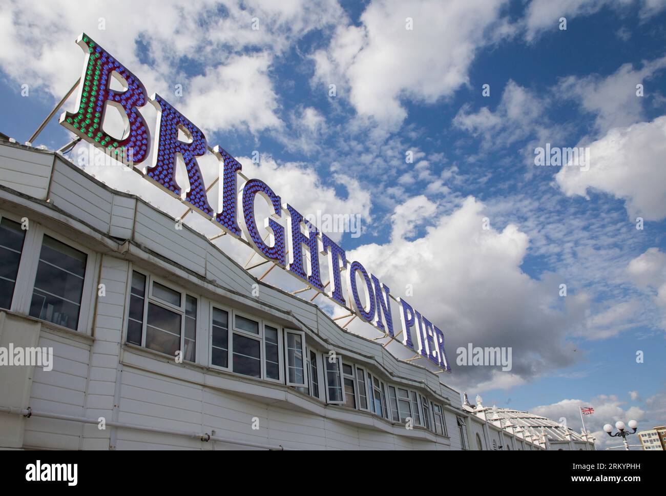 Brighton Pier neon sign with bright blue skies Stock Photo - Alamy
