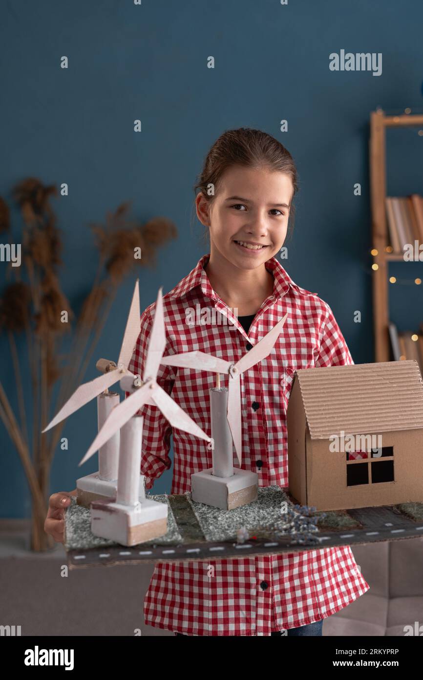 Portrait of a teenager girl with an ecological renewable energy project ...