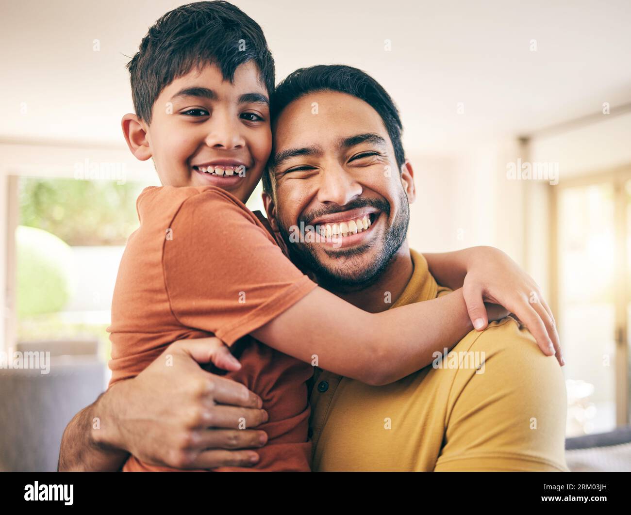Happy, portrait and father hugging his child in the living room of a ...