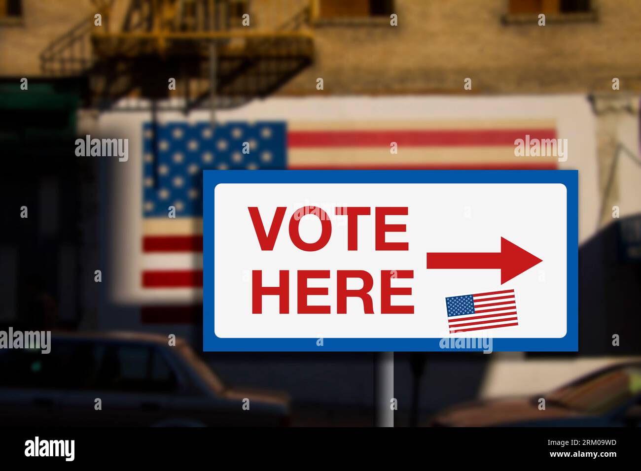 Vote Here sign. With American Flag and blurred background. Concept ...