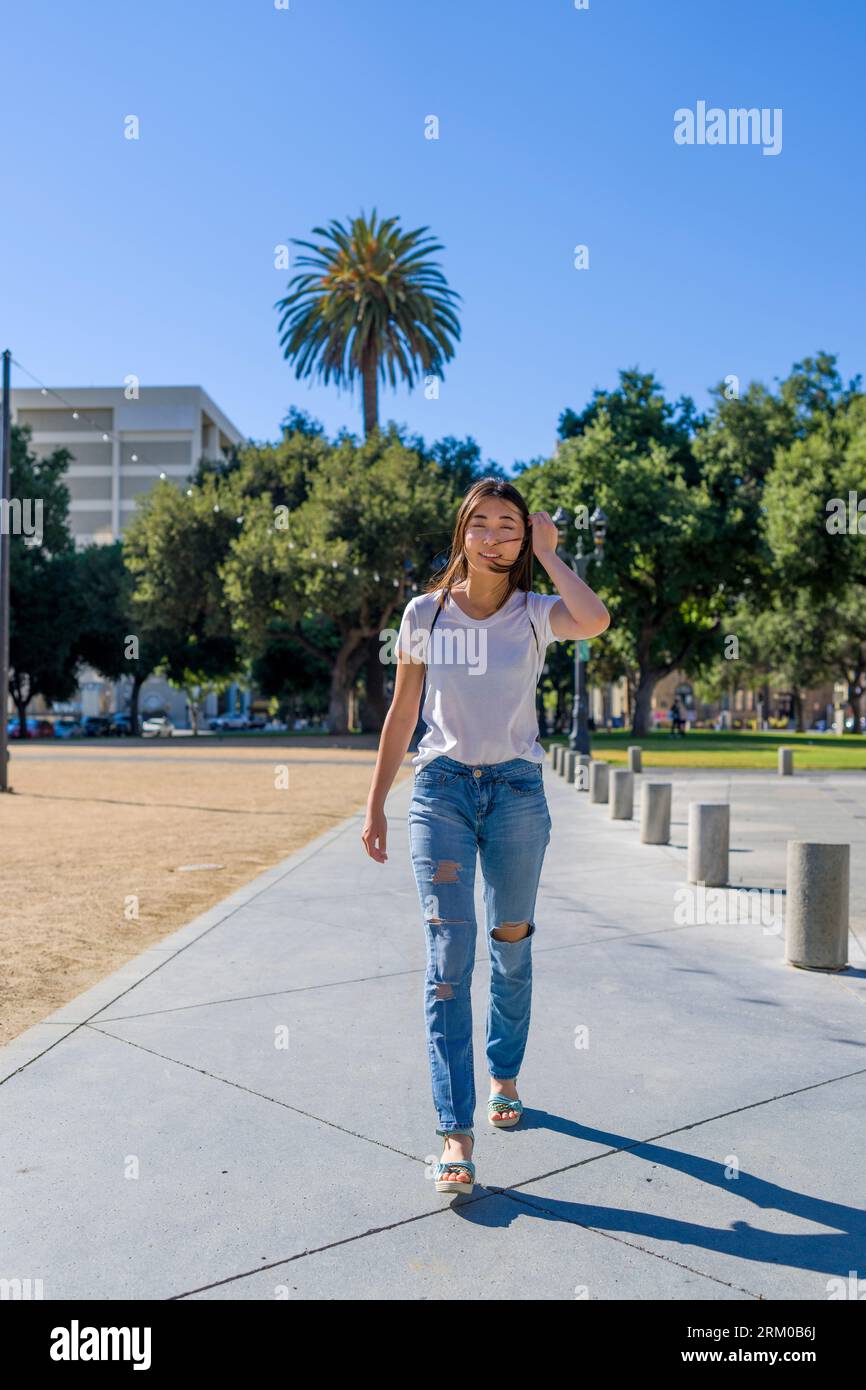 Young Asian Woman Walking in Park in Downtown San Jose Stock Photo - Alamy
