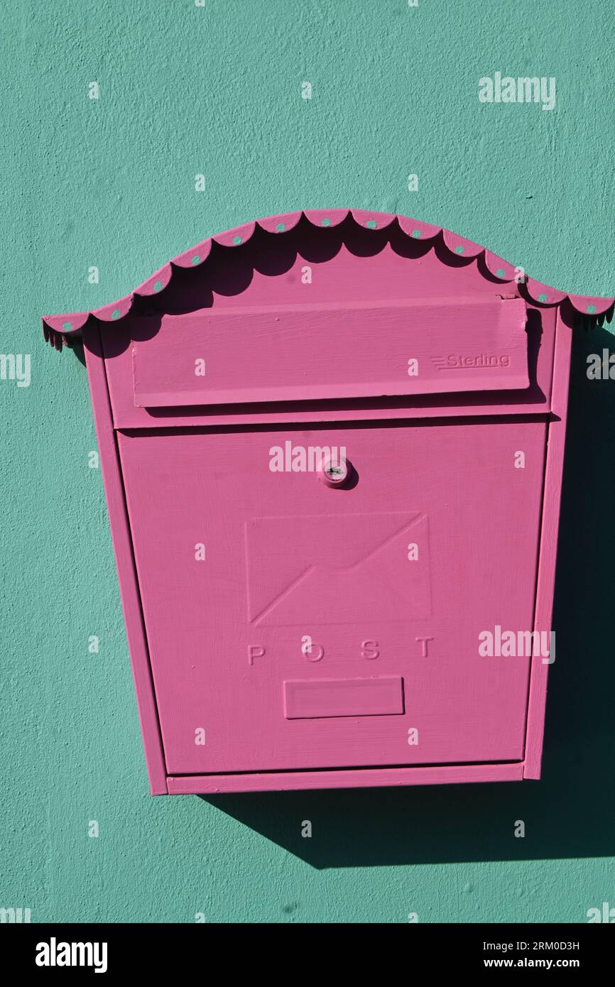 pink letter box on turquoise wall Stock Photo - Alamy