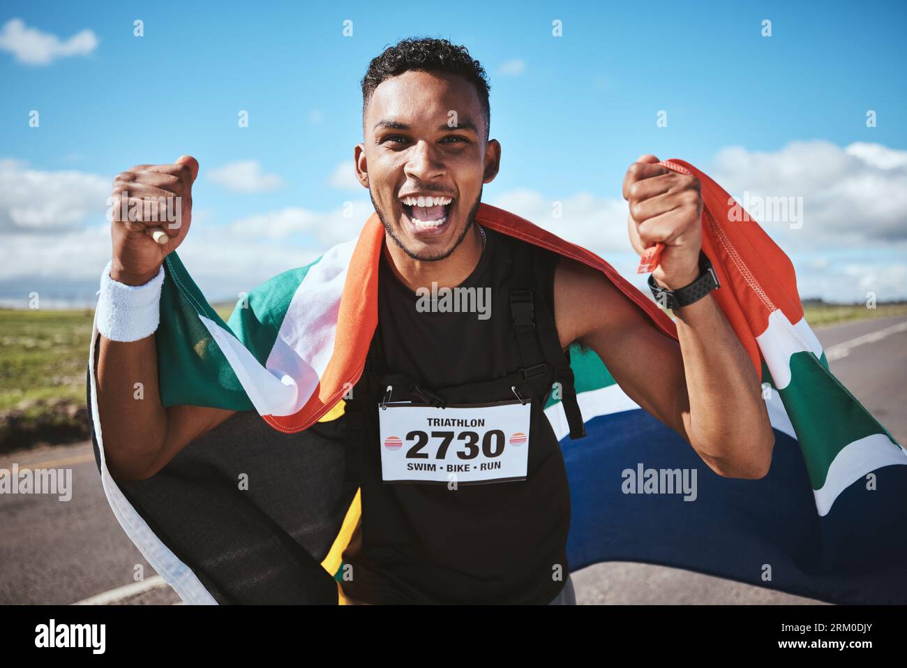 Portrait, fitness and flag of South Africa with a man runner on a ...