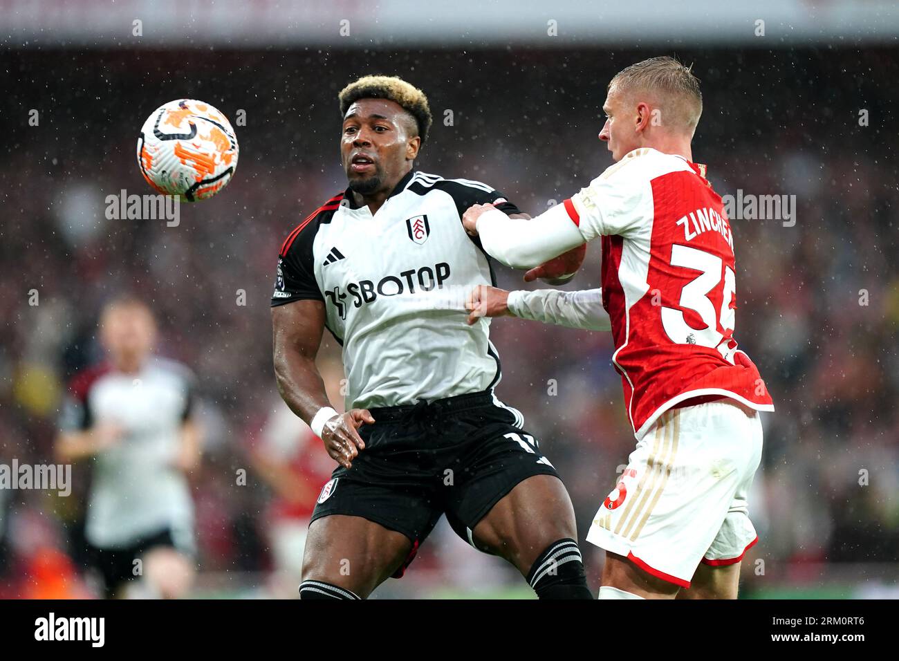 Fulham's Adama Traore (left) and Arsenal's Oleksandr Zinchenko battle ...