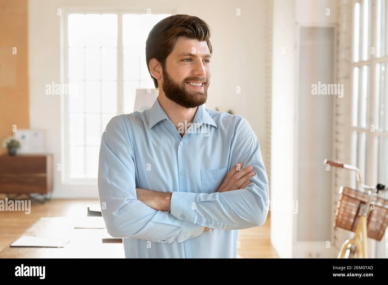 Pensive male employee look in distance thinking Stock Photo - Alamy
