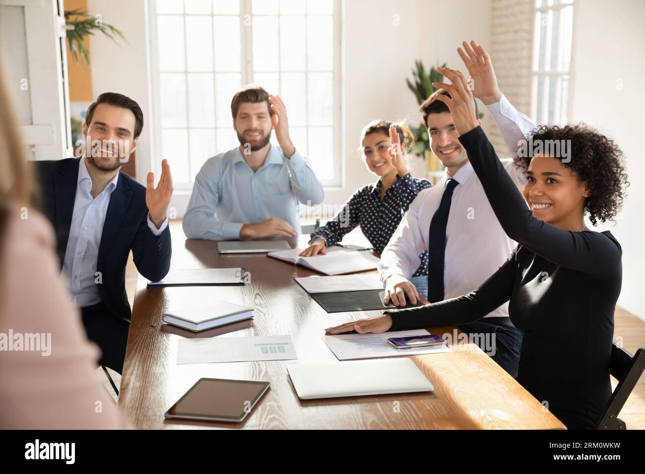 Diverse employees raise hands participate in team activity Stock Photo ...