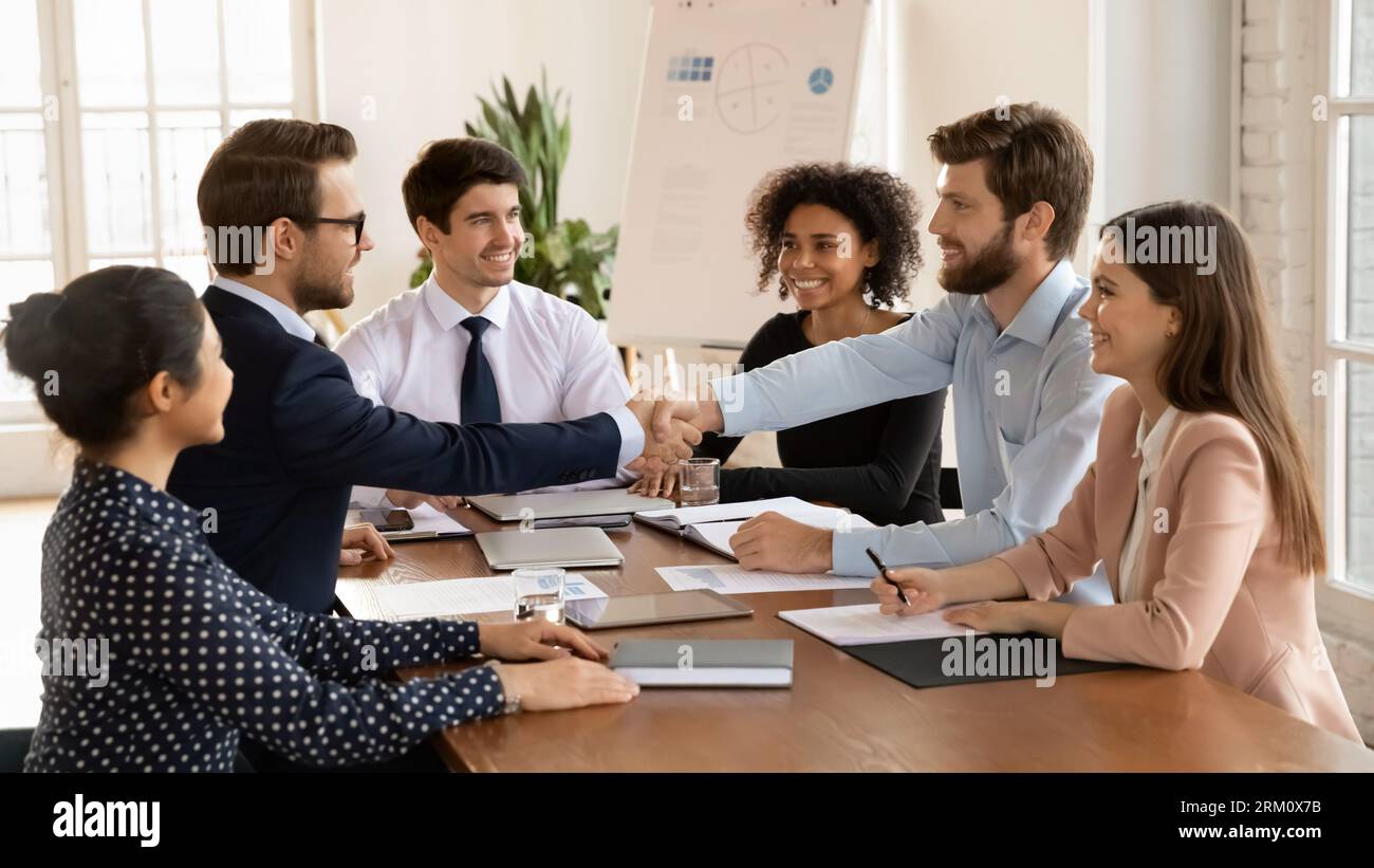 Diverse colleagues handshake closing hi-res stock photography and ...